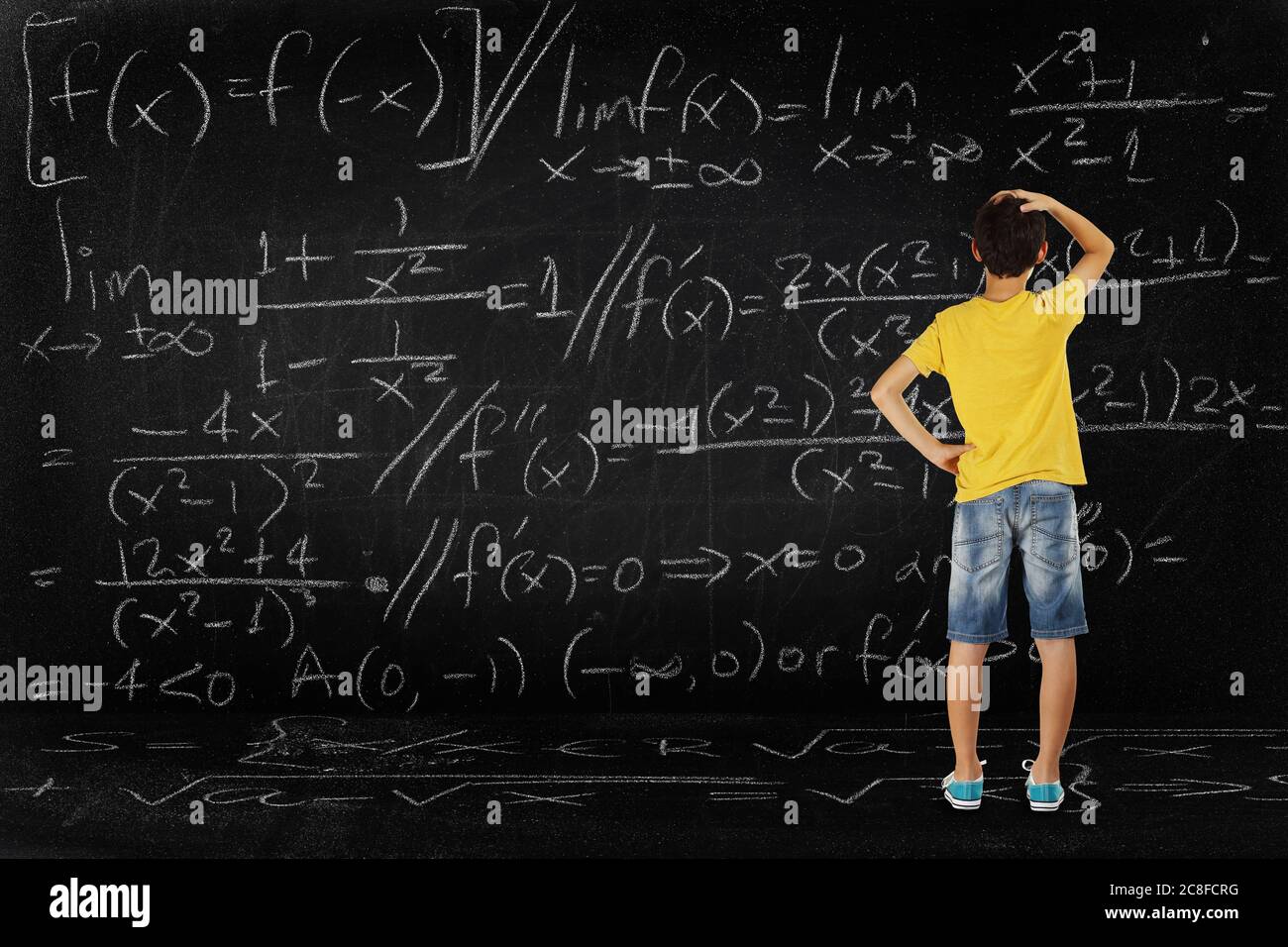 puzzled student looking at a huge blackboard with a diffiult equation ...