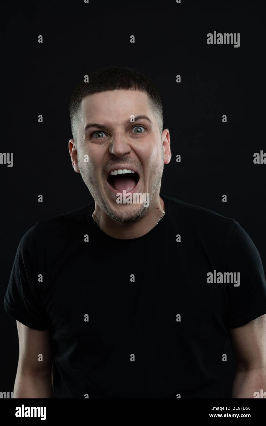Emotional young man with round eyes, open mouth, showing astonishment ... Emotional young man with round eyes, open mouth, showing astonishment ...
