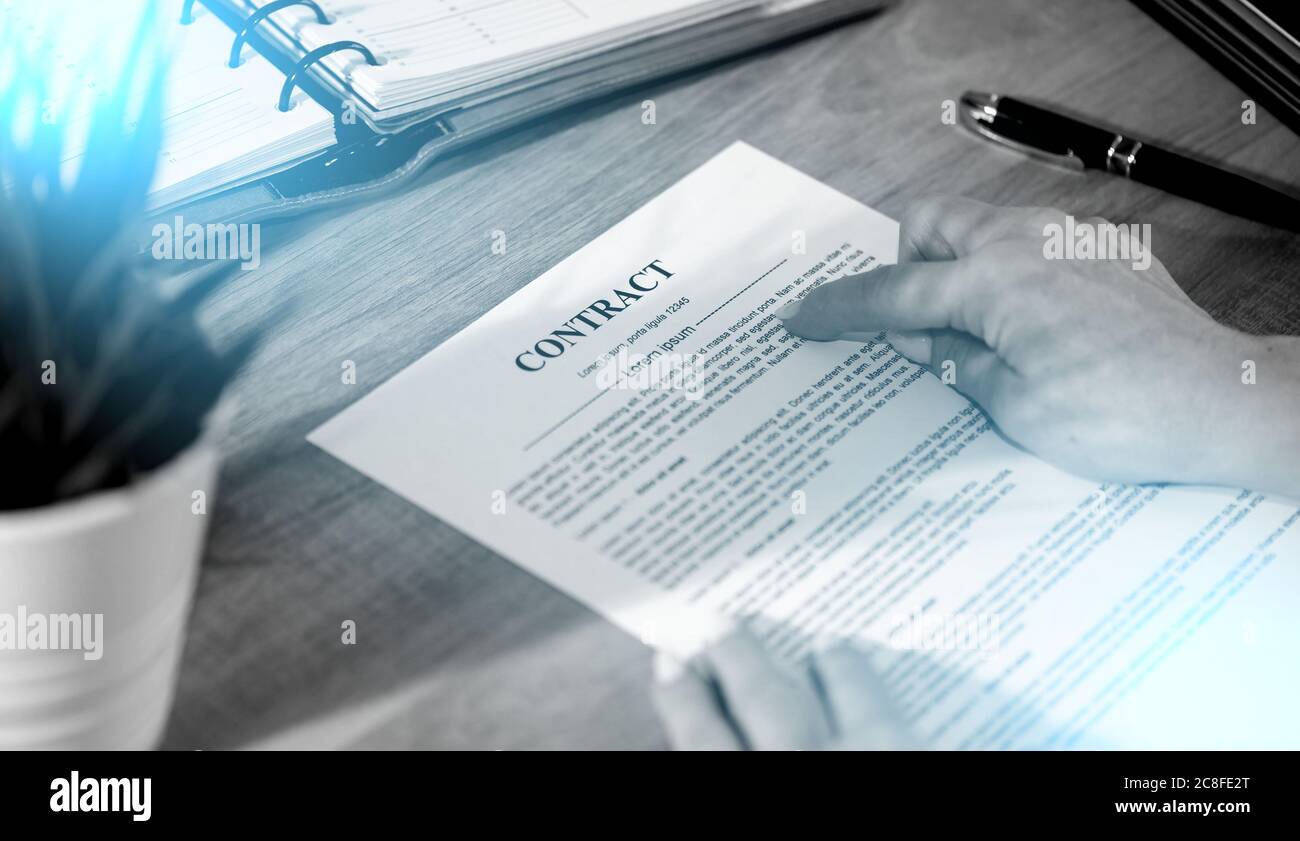 Female hands checking content of a contract; light effect Stock Photo ...