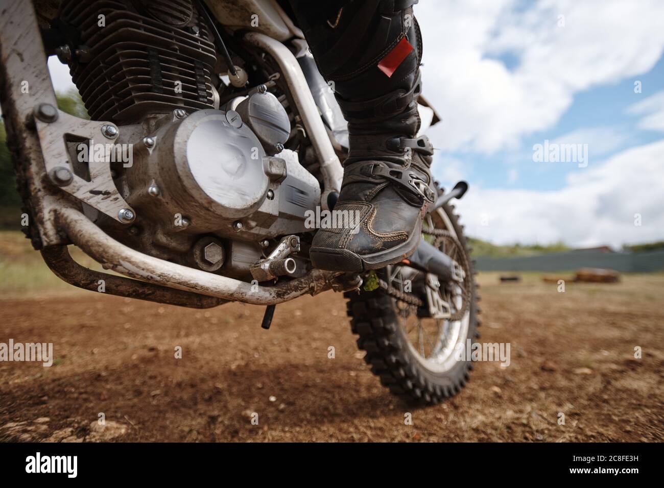 Close-up of unrecognizable motorcyclist keeping foot on pedal while ...