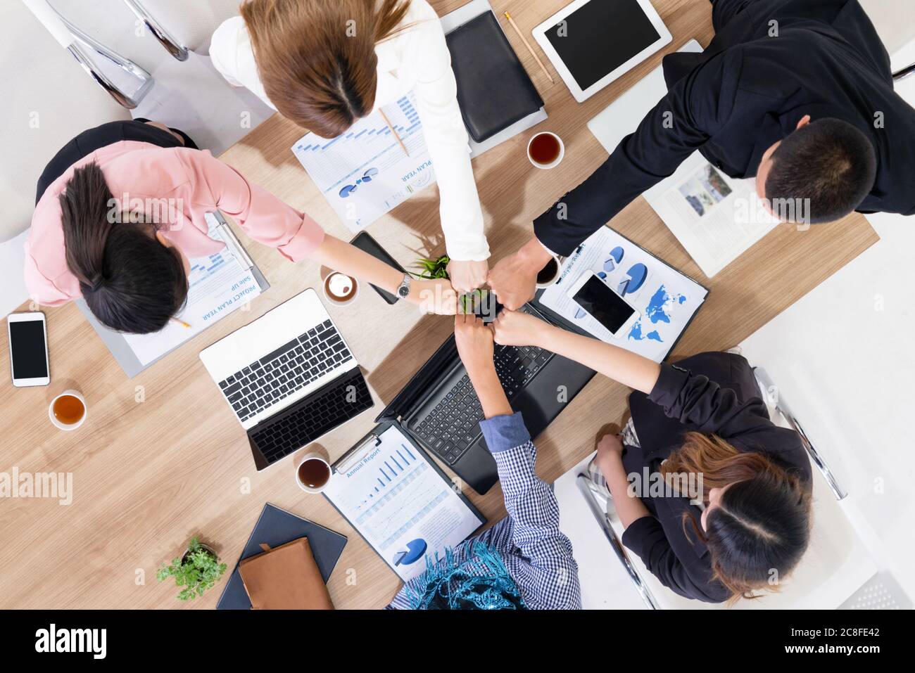 Teamwork business people join hands in meeting Stock Photo - Alamy