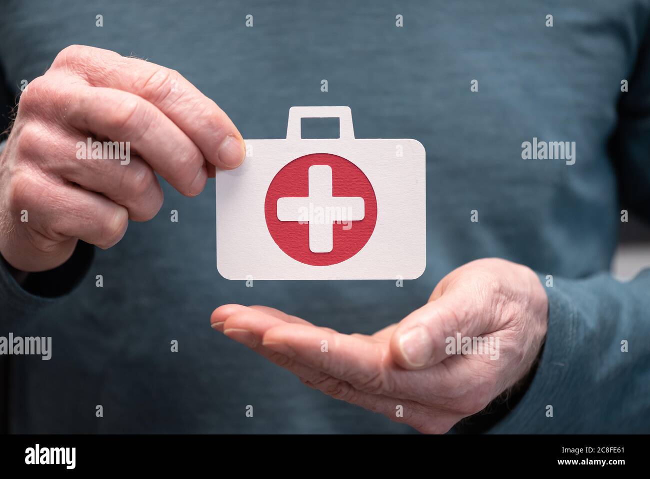 Man holding a paper medical briefcase; Symbol of health insurance Stock ...