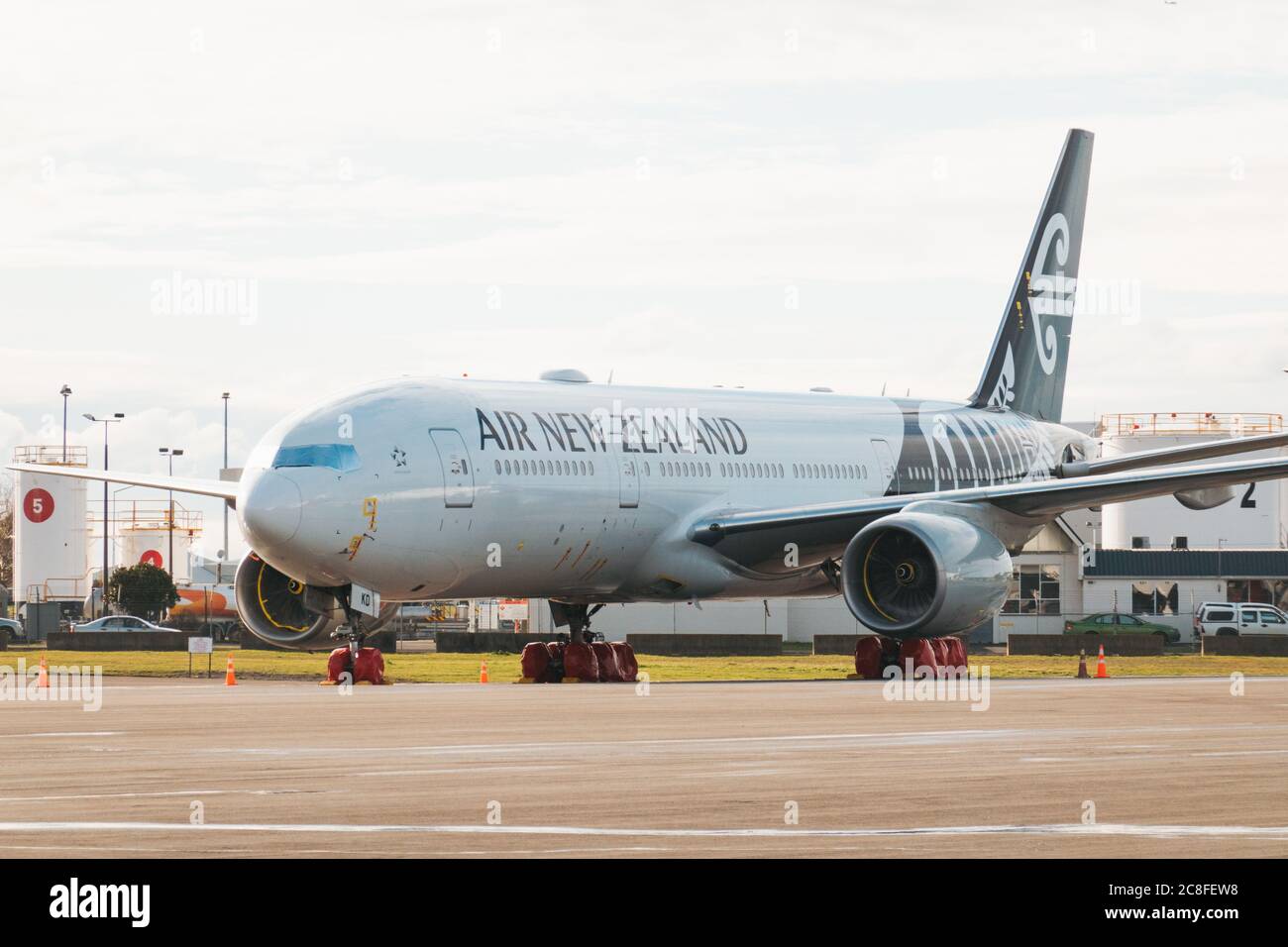 A Boeing 777 parked in storage with wheel and engine covers in ...