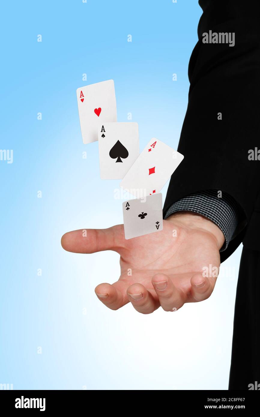four aces falling into a man's hand Stock Photo - Alamy