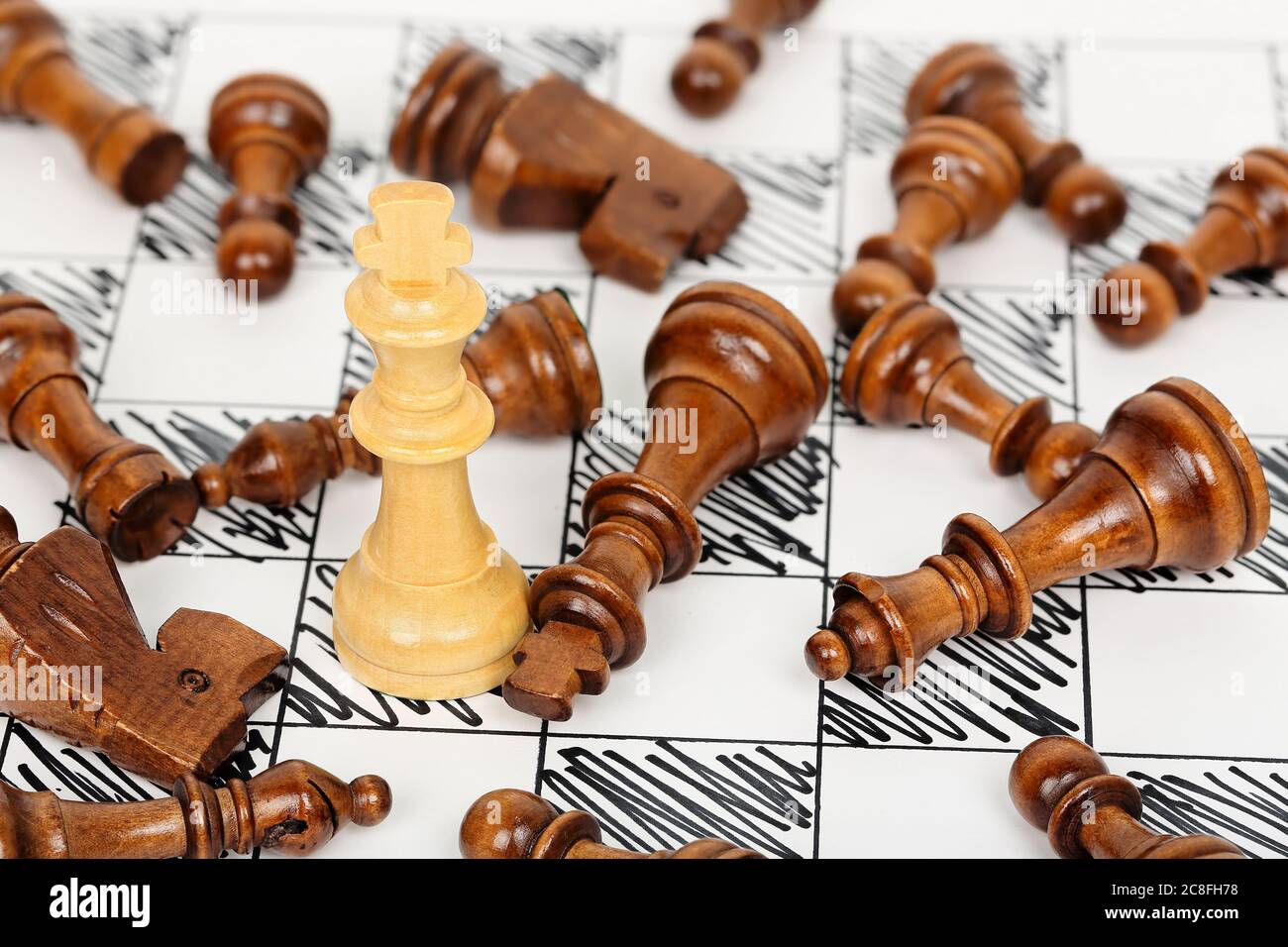 white chess king surrounded by fallen opponents Stock Photo - Alamy