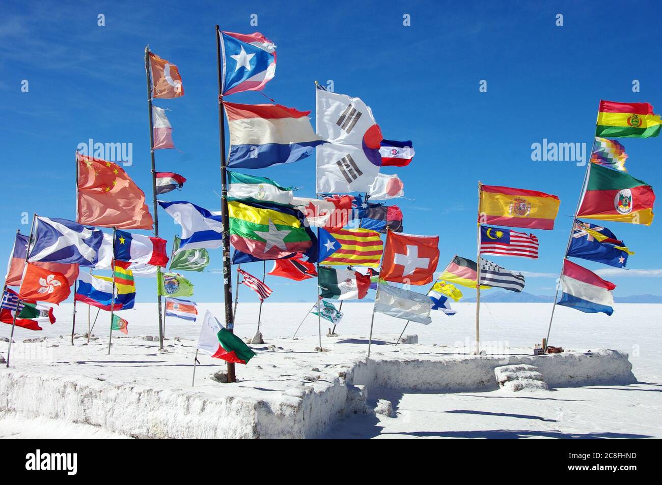 Various national flags in the salt flats of Uyuni, Bolivia Stock Photo ...