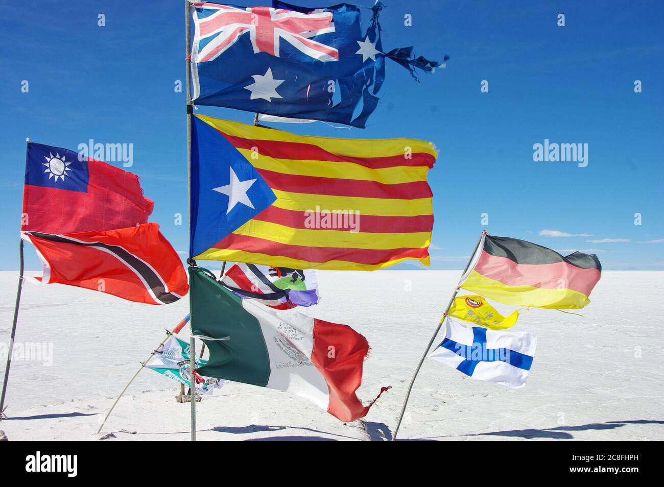 Various national flags in the salt flats of Uyuni, Bolivia Stock Photo ...
