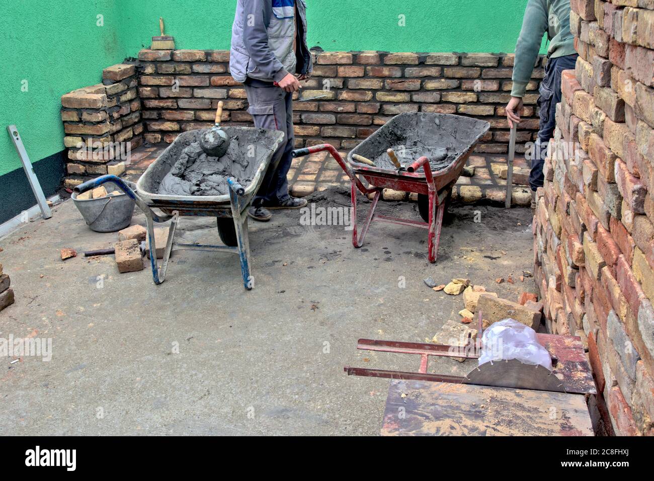 Parked trolley, mortar and tools to help build the building. Several of ...