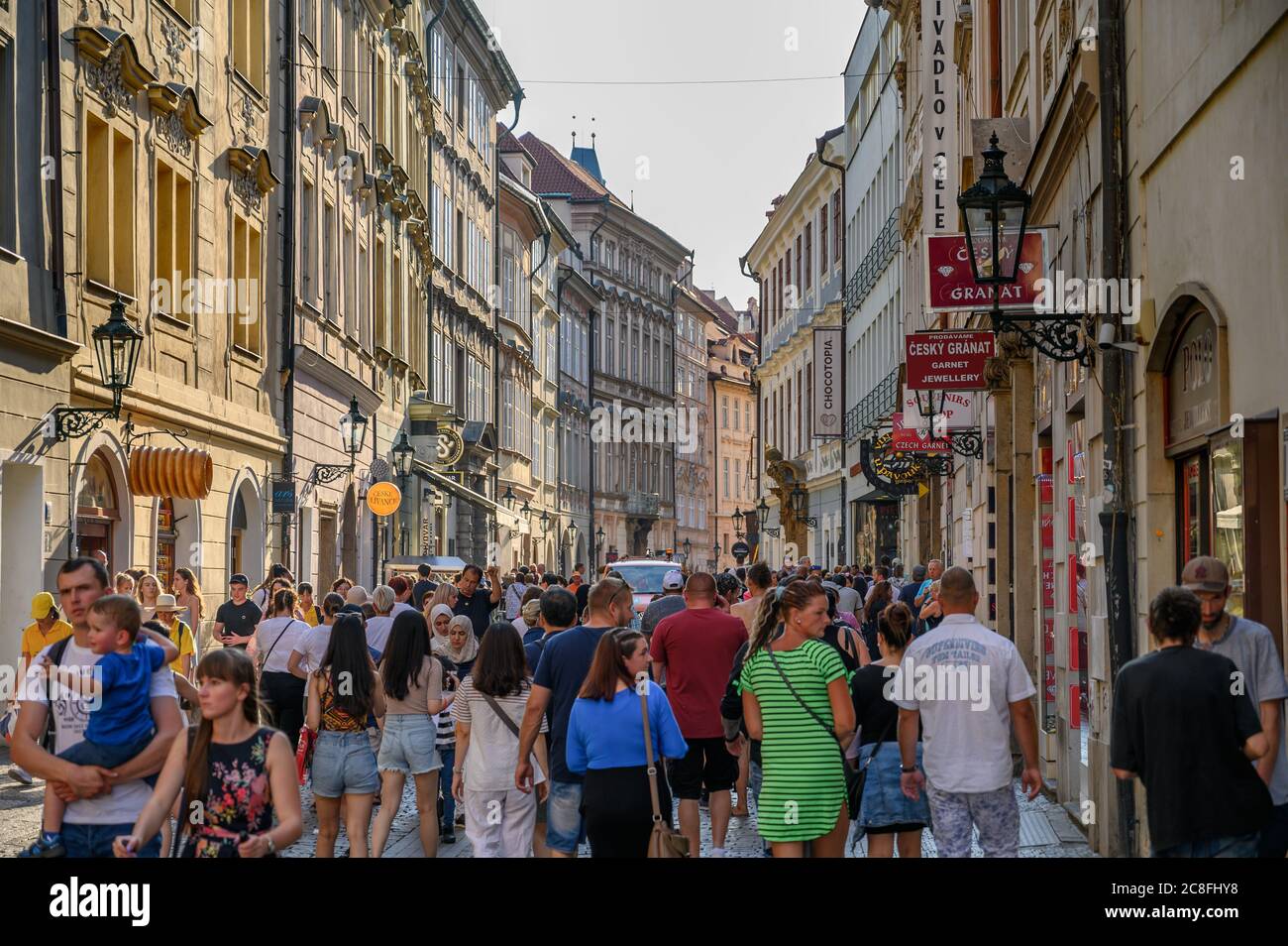 PRAGUE - JULY 20, 2019: Crowded tourist street scene between old shop buildings in Prague, Czech ...