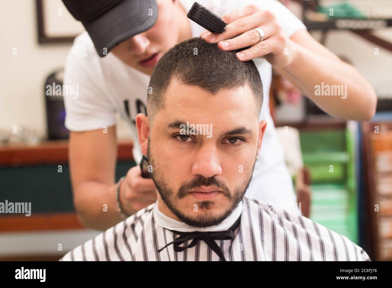 Closeup shot of a young male getting a new stylish haircut in the ...