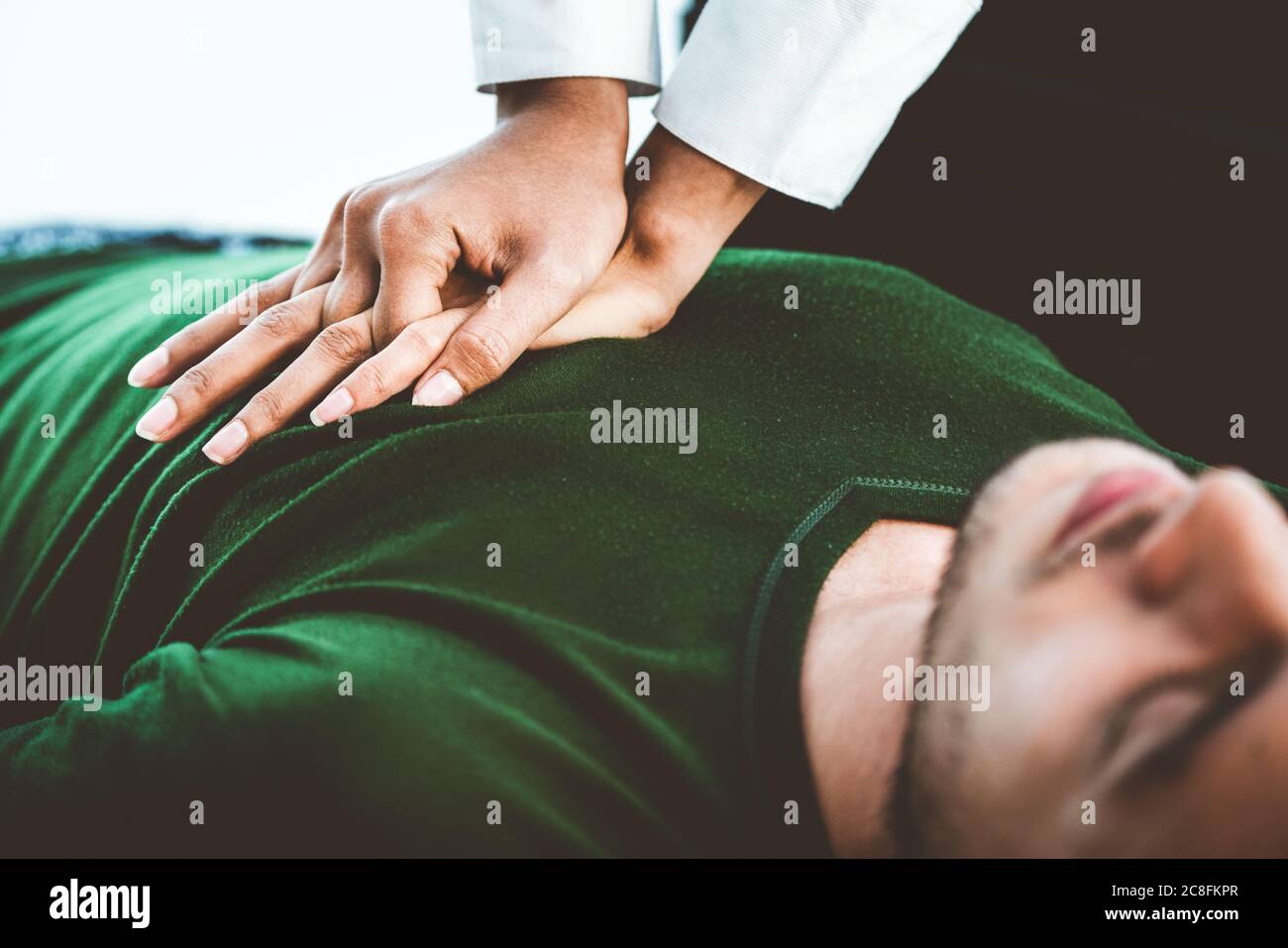 Rescuer hands doing CPR on heart attacked man Stock Photo - Alamy