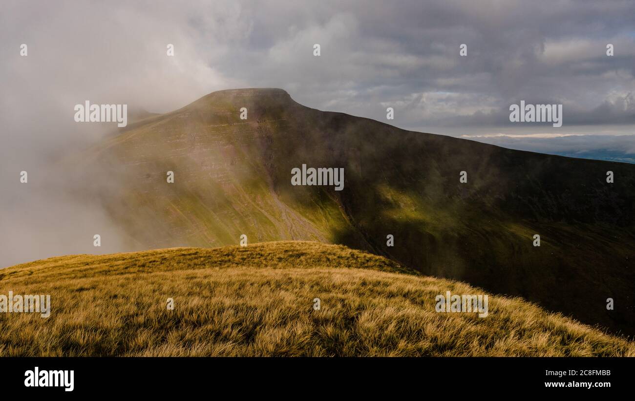 BRECON BEACONS, WALES - 24 JULY 2020: A misty Brecon Beacons as the sun ...
