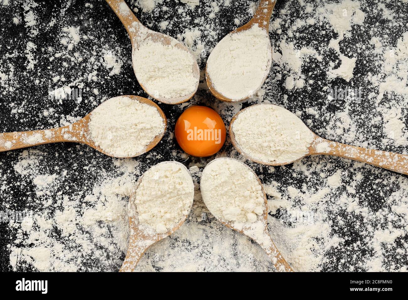 ladles with flour around an egg yolk Stock Photo - Alamy