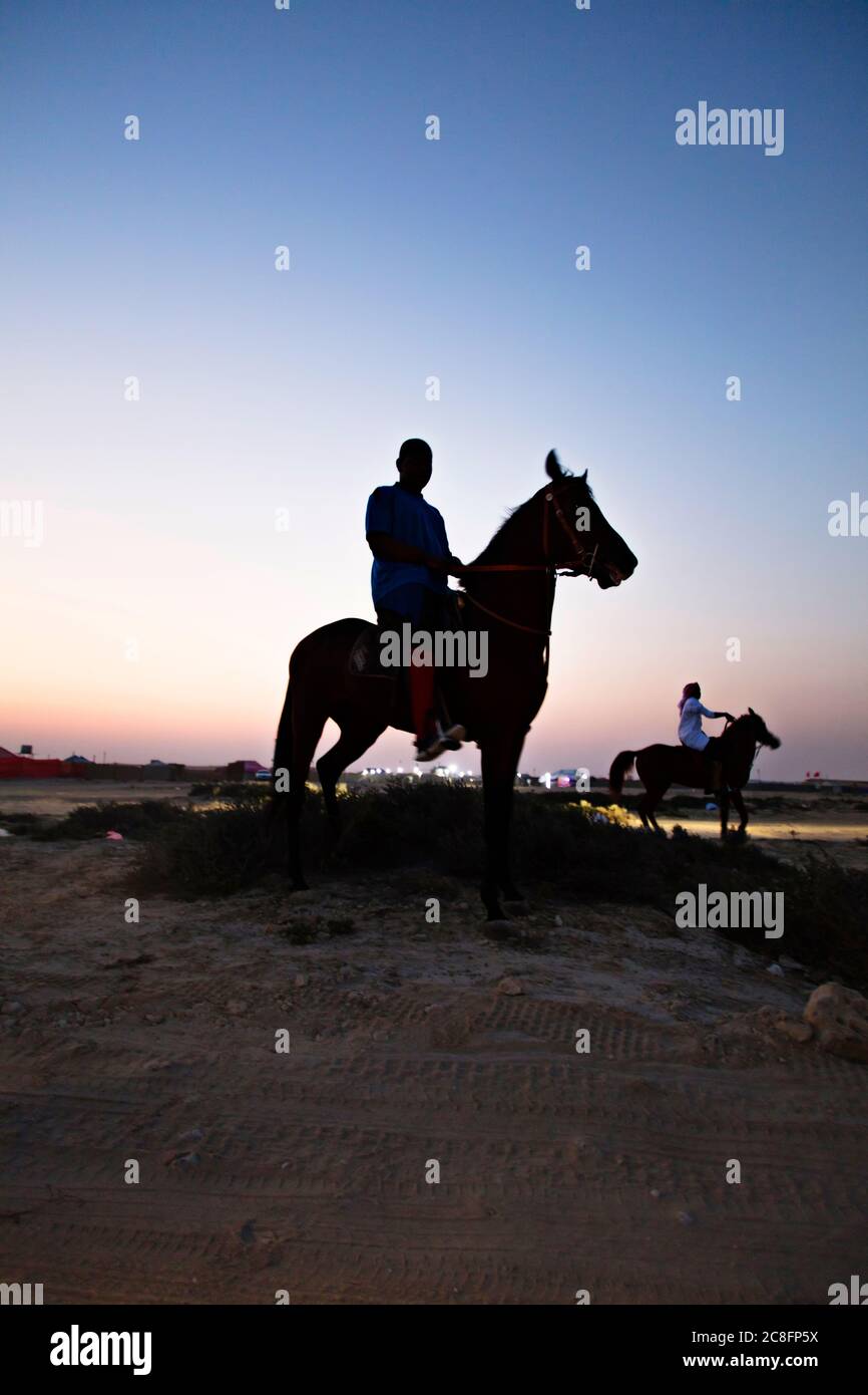 Riding horses at sunset hi-res stock photography and images - Alamy