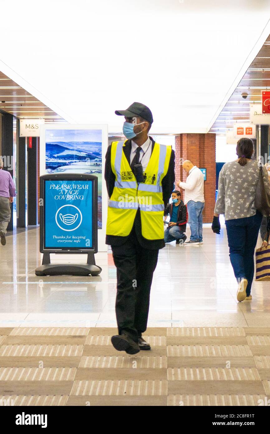 London, UK. Friday, 24 July, 2020. A security guard wearing protective ...