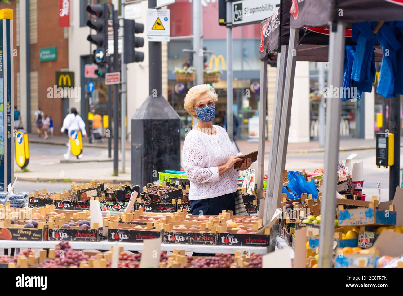 London, UK. Friday, 24 July, 2020. A shopper wearing a protective mask ...