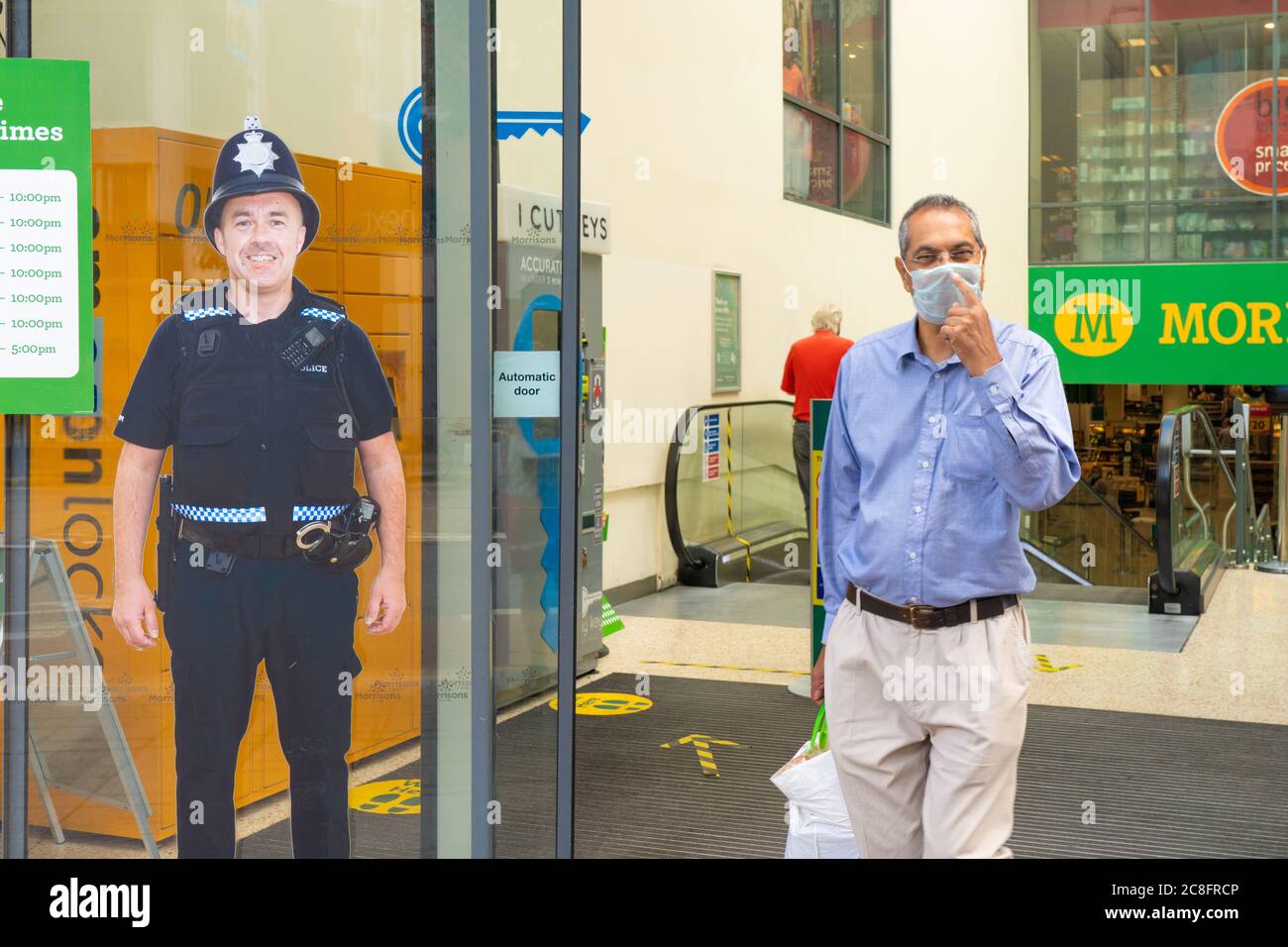 London, UK. Friday, 24 July, 2020. A shopper wearing a protective mask ...