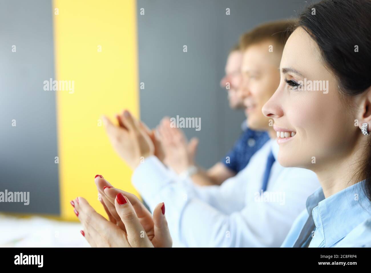 Business woman and businessmen sit and clap their hands Stock Photo - Alamy