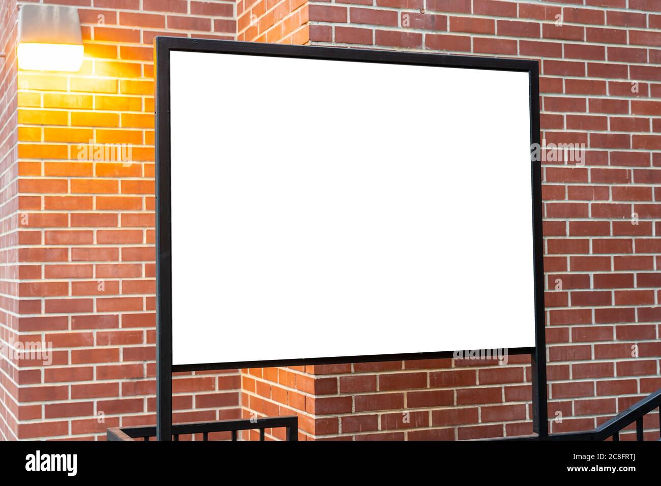 Square billboard in front of a brick wall Stock Photo - Alamy