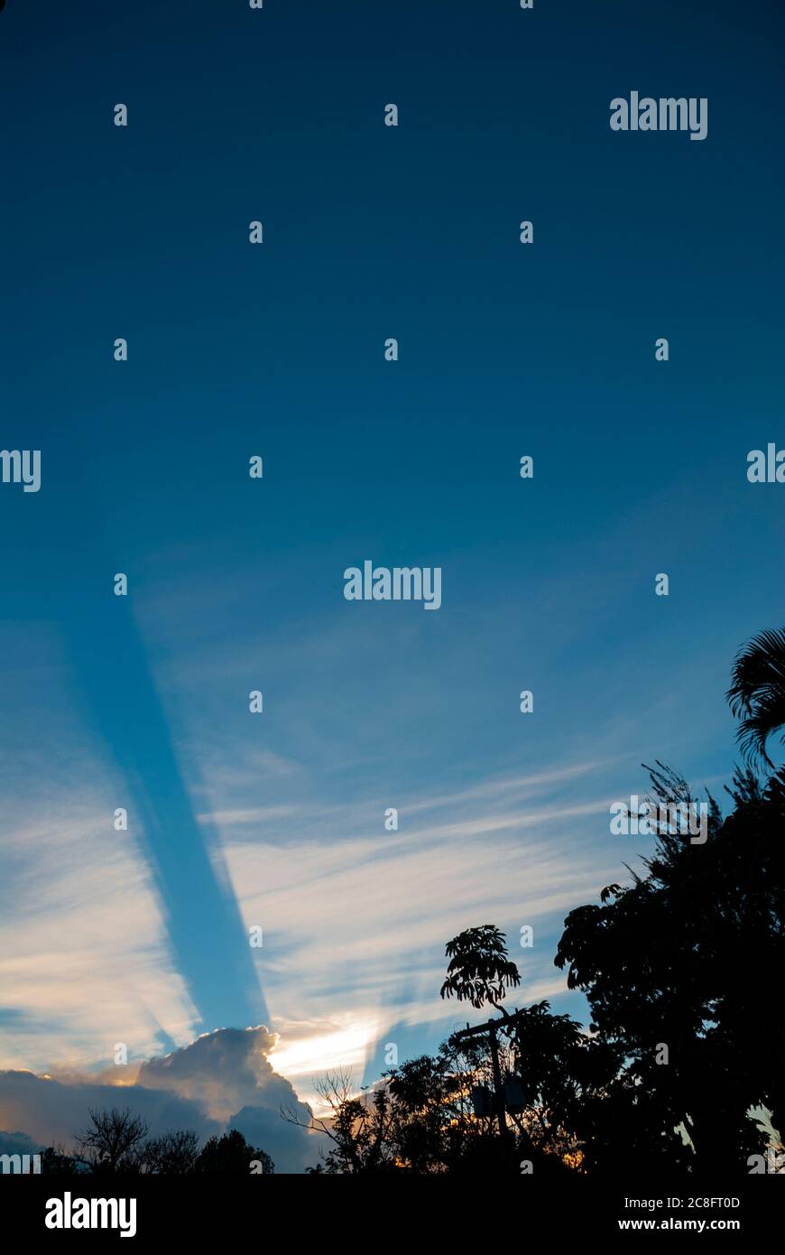 Sunset with clouds and shadows with partially clear sky, shadows cast ...