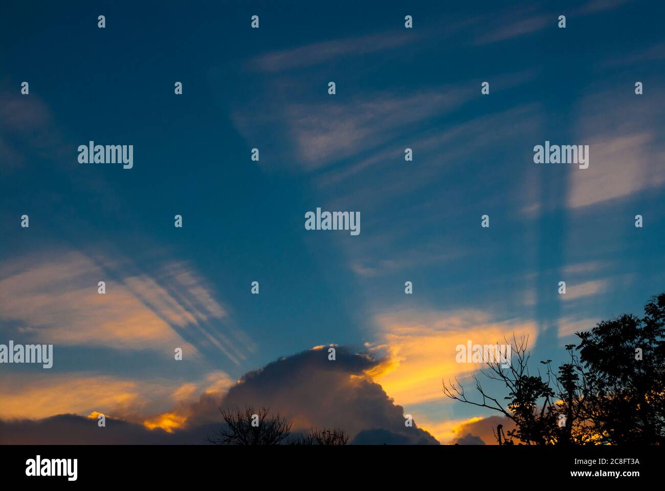Sunset with clouds and shadows with partially clear sky, shadows cast ...