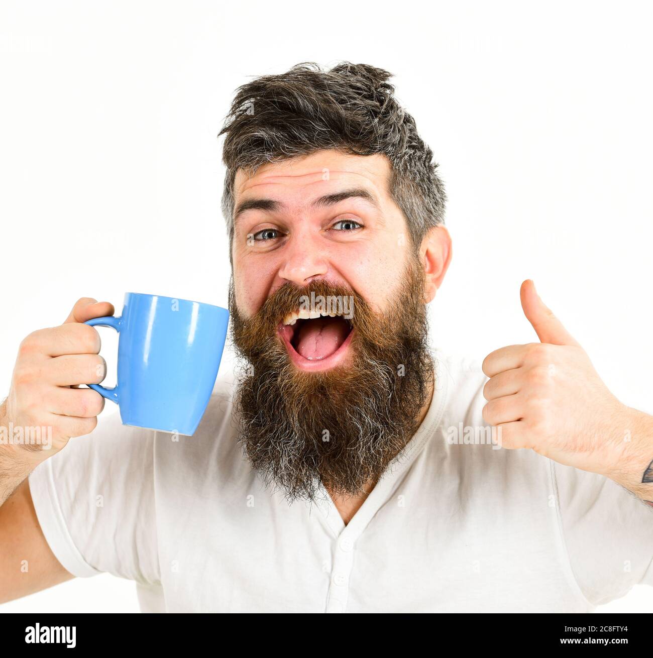 Energetic and successful macho shows thumb up gesture. Hipster with ...