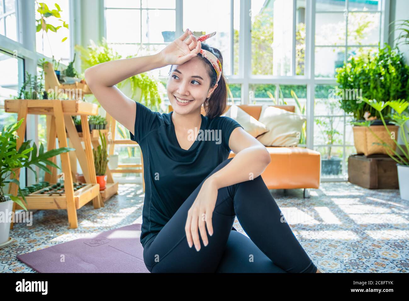 Smile happy Beautiful Asian Young fitness sport woman is resting tired ...