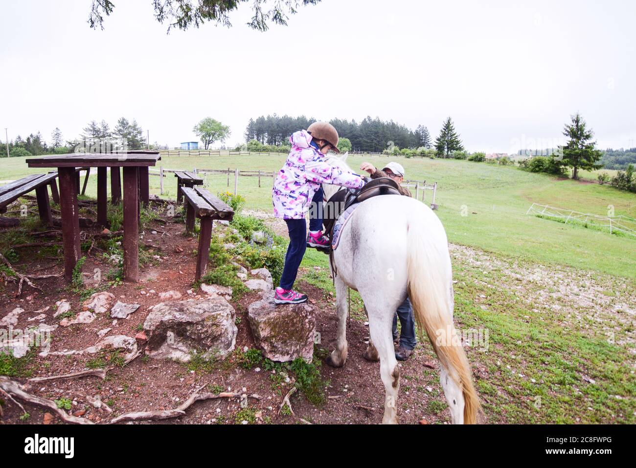 Horseback riding lesson- little girl getting a horse at ranch , country ...
