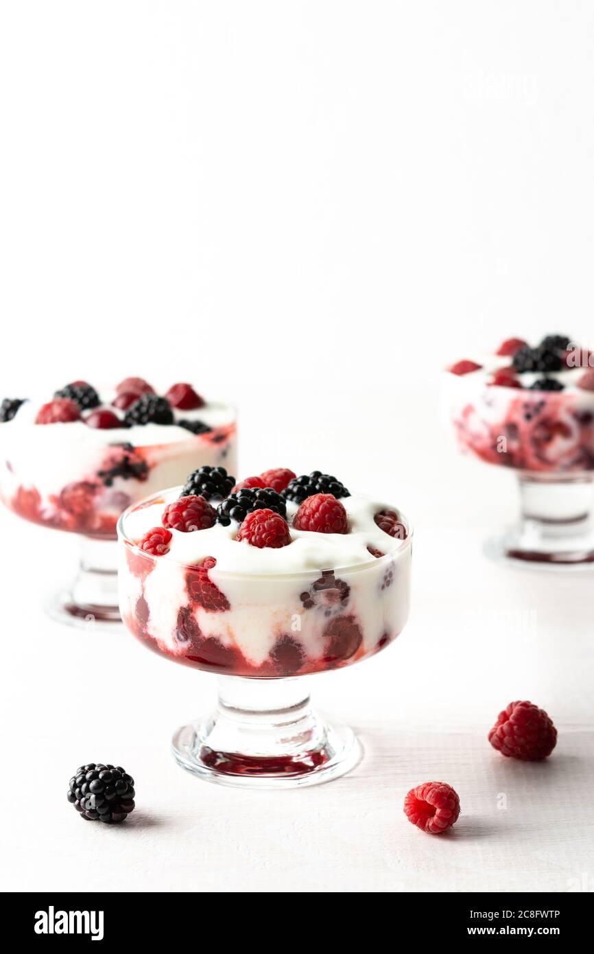 Delicious juicy berries of raspberries and blackberries with yoghurt in ...