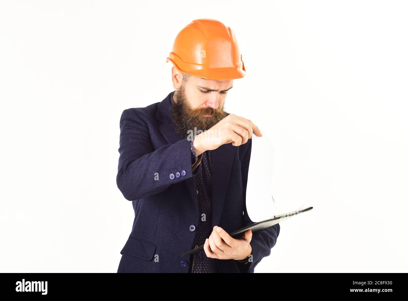 Supervisor with papers, helmet and serious face. Inspector holds ...