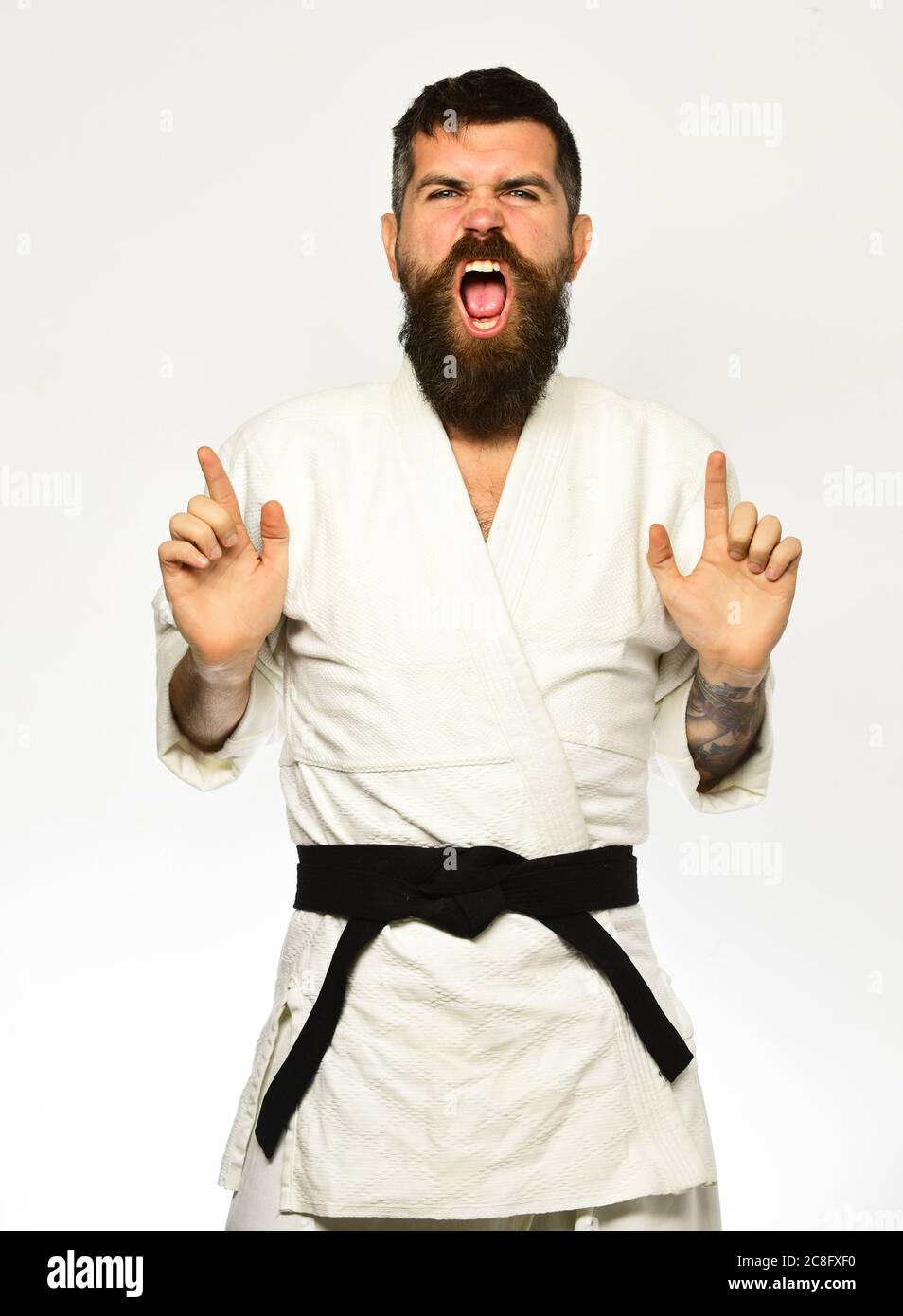 Healthy lifestyle and sports concept. Karate man with angry face in ...
