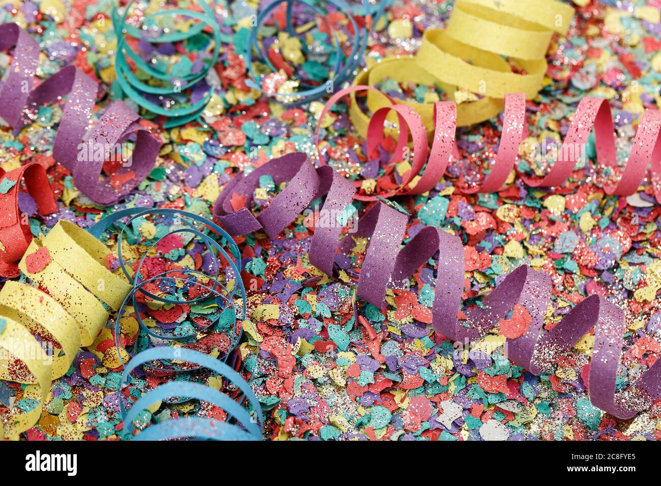 colorful party streamers on confetti Stock Photo - Alamy
