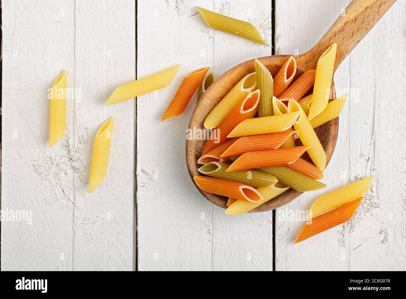 colorful penne pasta on wooden ladle Stock Photo - Alamy