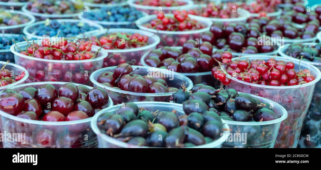 berries of different varieties are Packed in plastic cups. selective ...