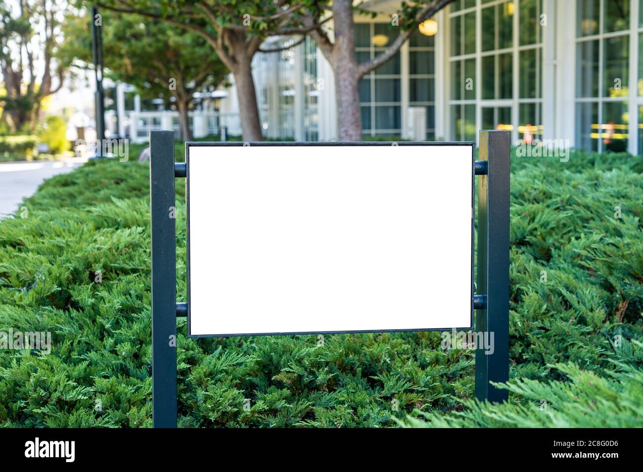 White company sign mockup in a garden Stock Photo - Alamy
