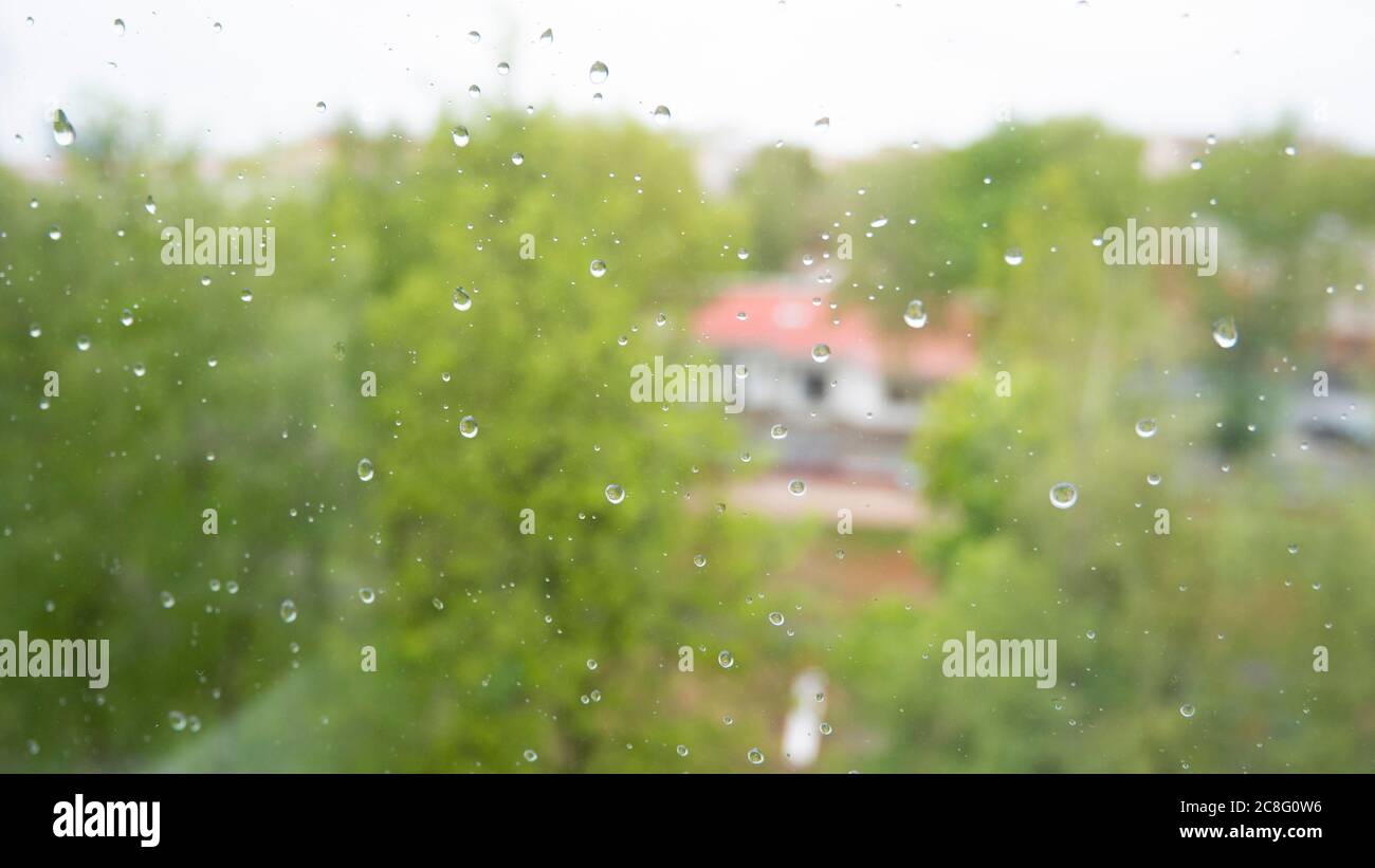 Rain drops on glass. Wet window with raindrops, nature background ...