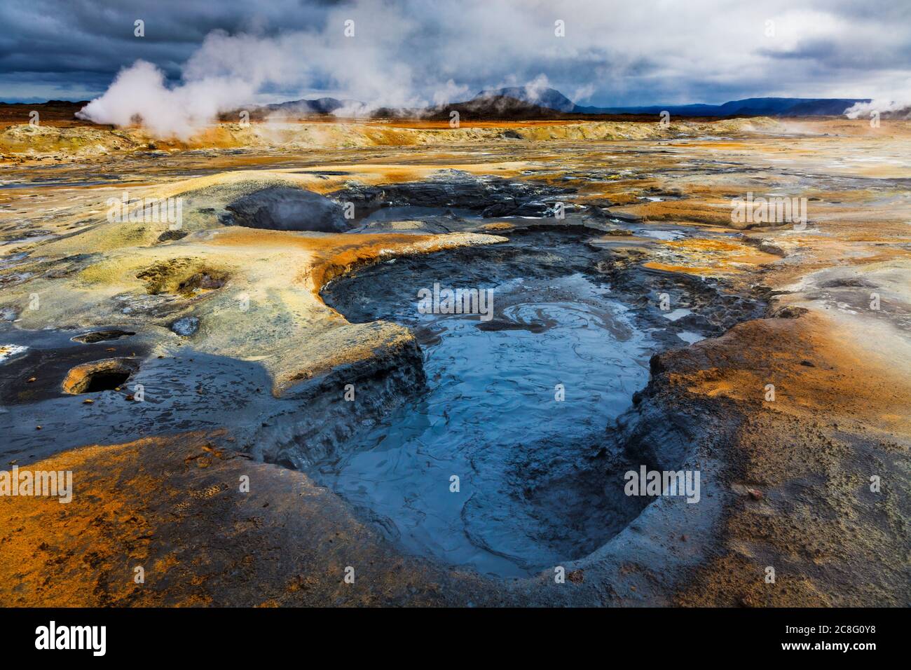 geography / travel, Iceland, Blue puddles of mud boil under the intense ...