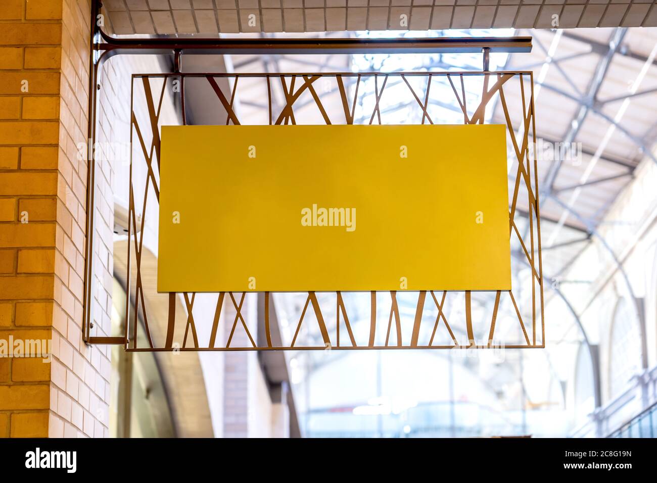 Yellow company sign mockup on a brick wall Stock Photo - Alamy