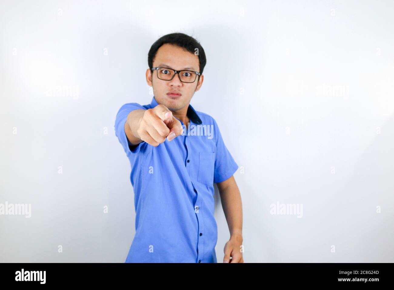 Young Asian Man wear blue shirt is funny angry face with shouting and ...