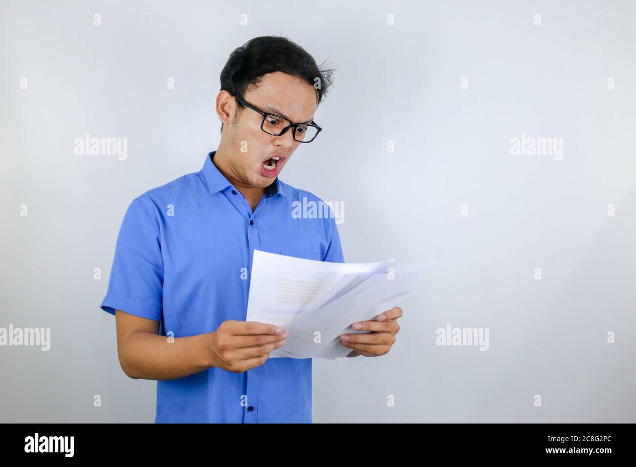Surprised man reading documents hi-res stock photography and images - Alamy