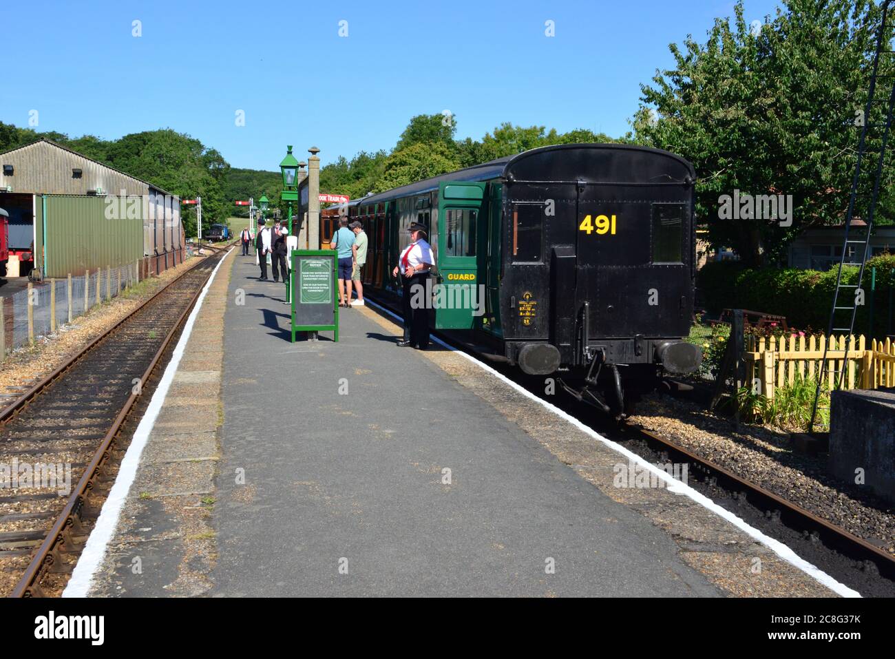 Passenger getting on a train at Haven station in the Isle of Wight ...
