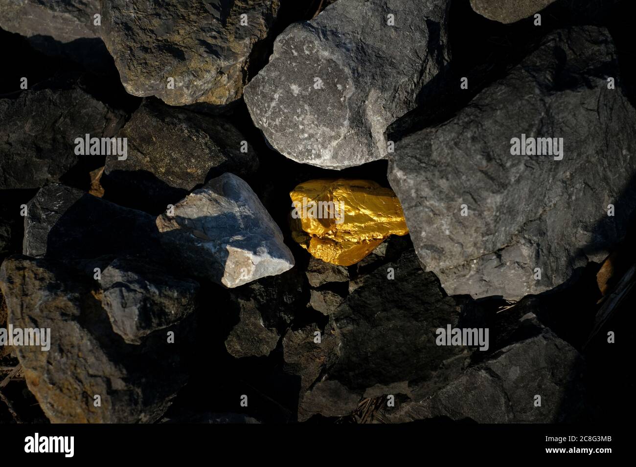 Gold nugget and grey granite stone background Stock Photo - Alamy