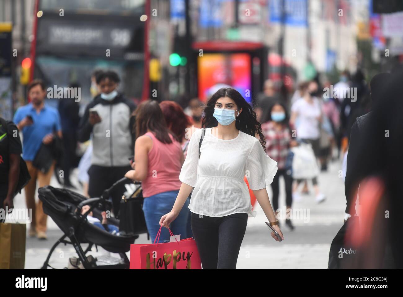 People wearing face masks on Oxford Street, London, as face coverings ...