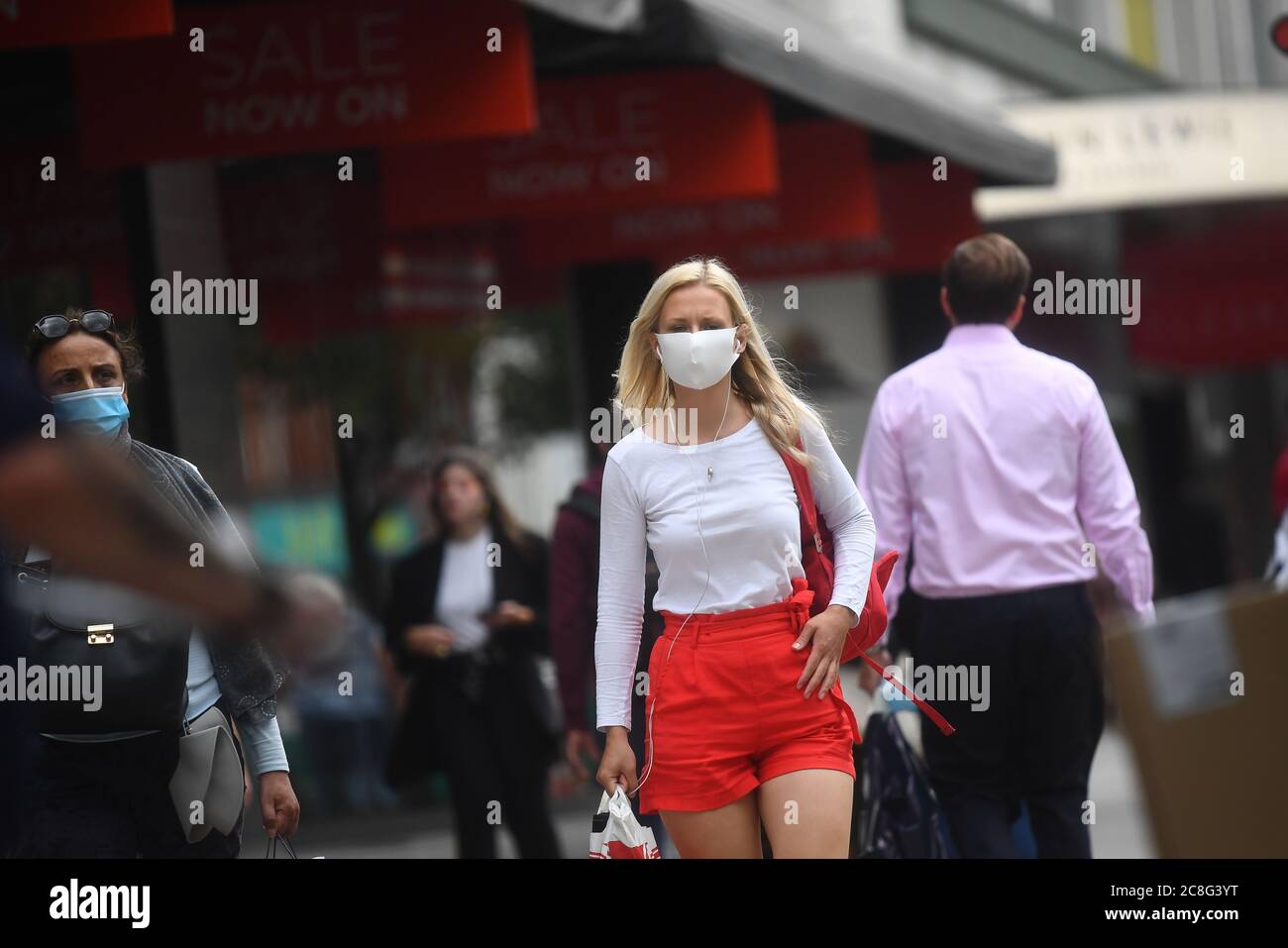 People wearing face masks on Oxford Street, London, as face coverings ...
