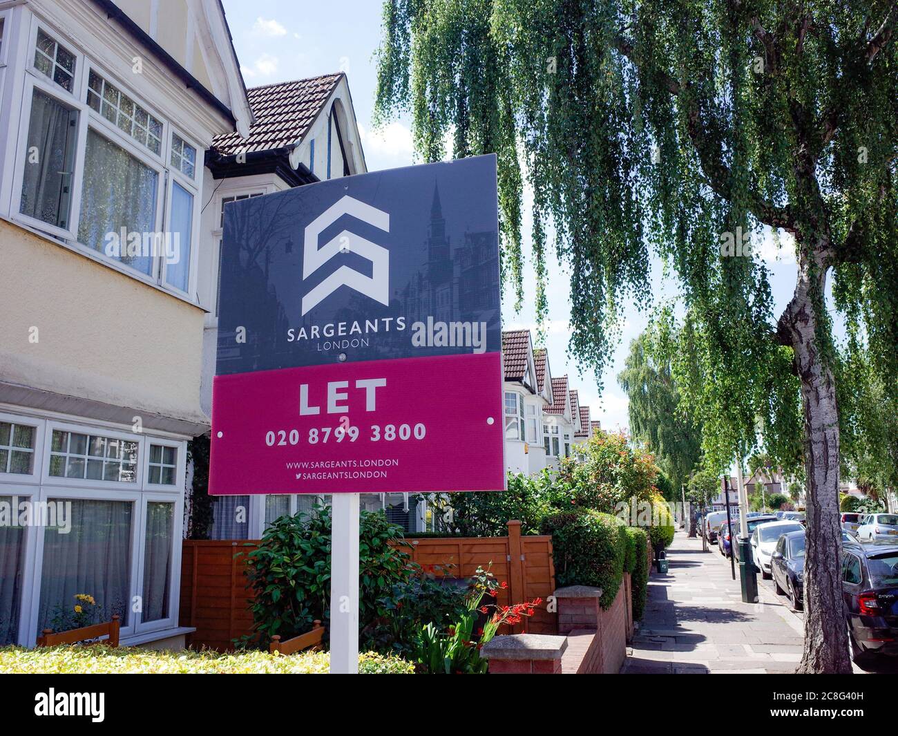 Estate Agent sign on street of houses in Ealing, West London Stock ...