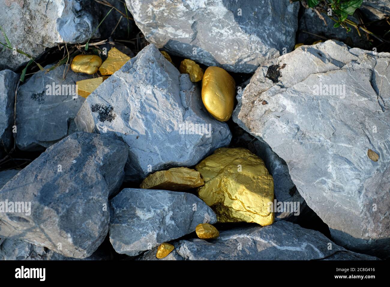 Gold nugget and grey granite stone background Stock Photo - Alamy
