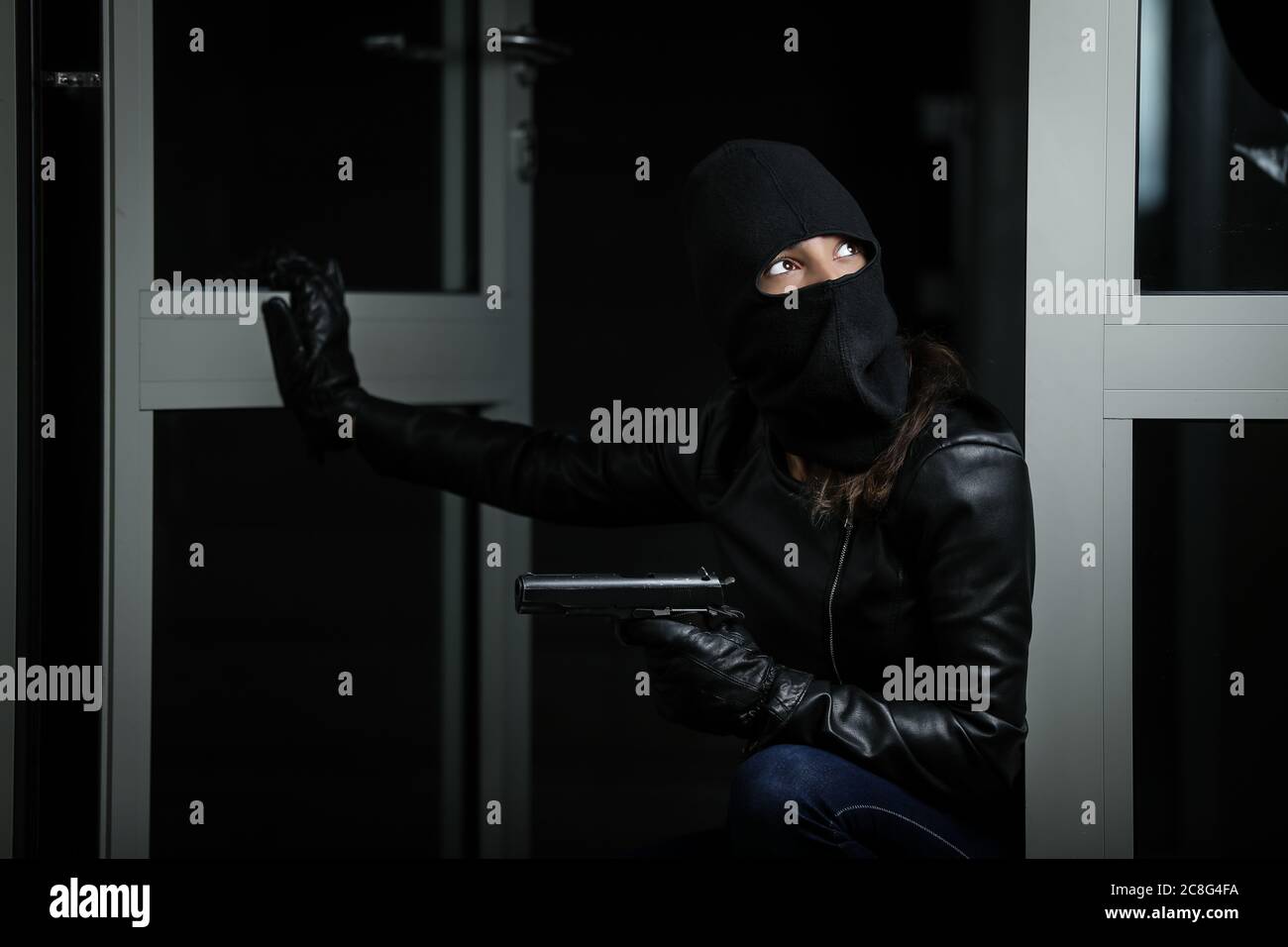 Thief broke into the apartment. House robbery by woman in a black ...