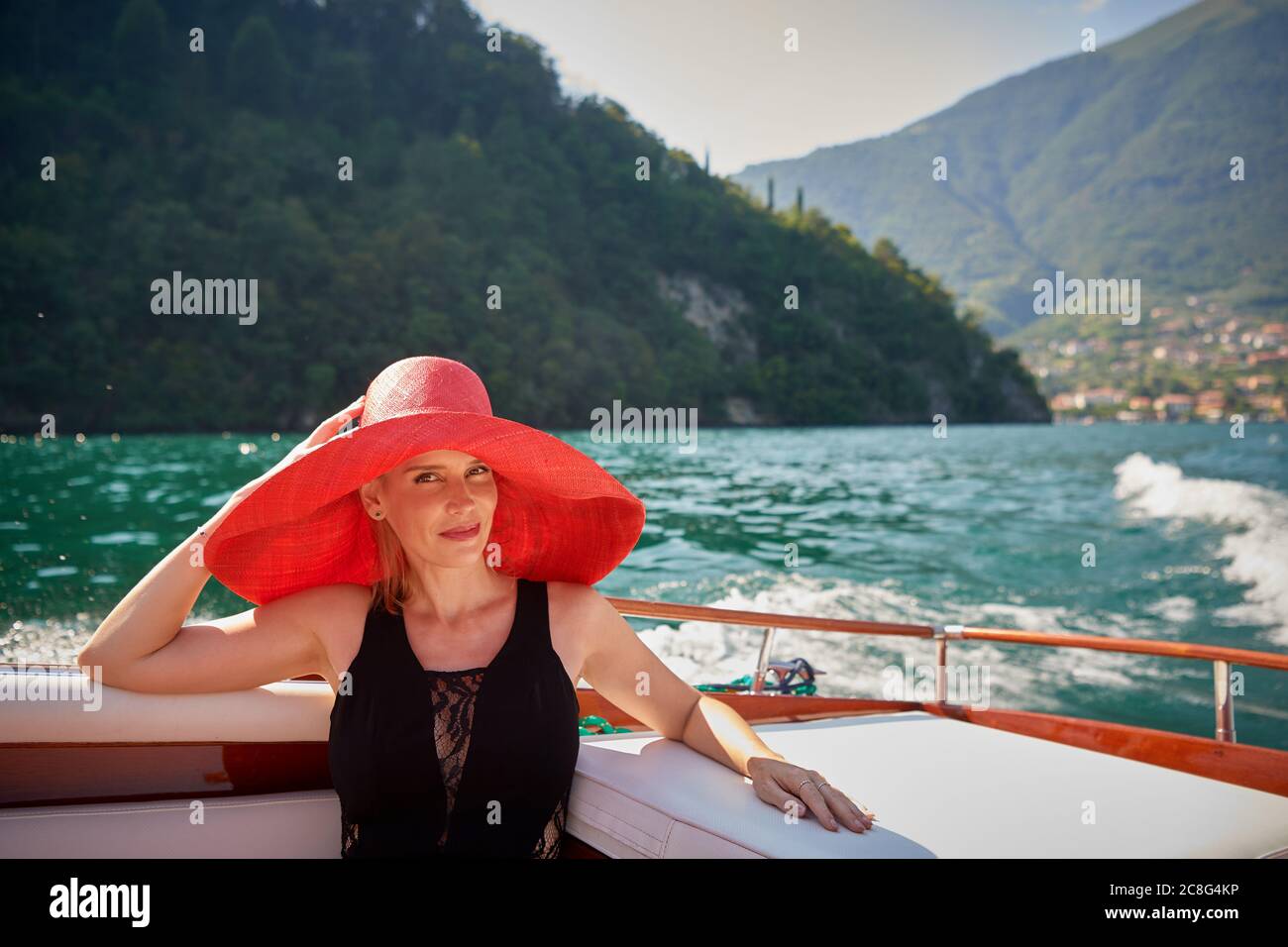 Beautiful model aboard a vintage wooden speedboat on Lake Como, Italy ...