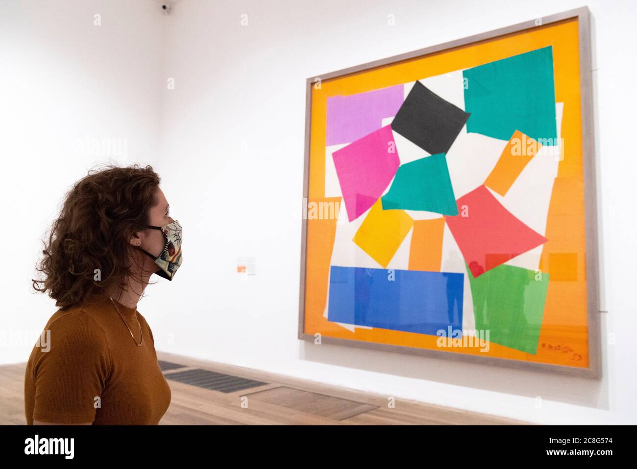 London, Britain. 24th July, 2020. A staff member wearing a face mask ...