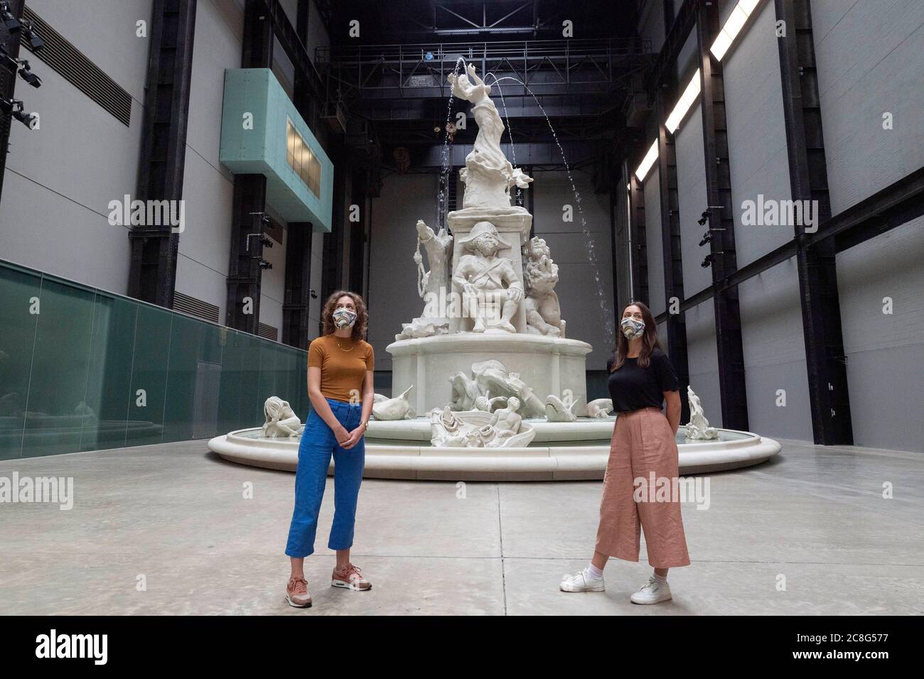 London, Britain. 24th July, 2020. Staff members wearing face masks ...